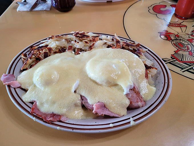 Eggs Benedict with a twist—ham piled high under perfectly poached eggs and hollandaise sauce that's practically drinkable. Breakfast nirvana achieved.