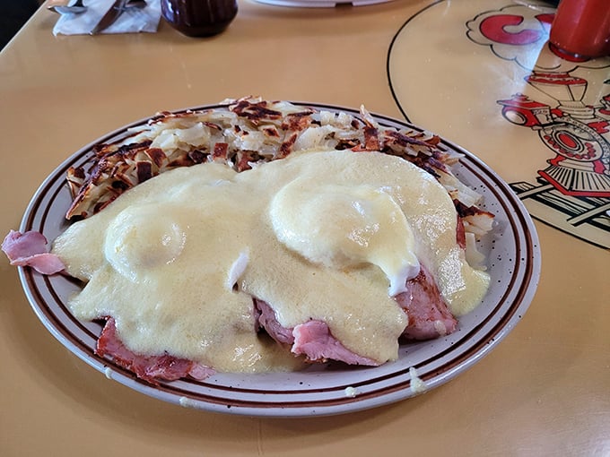 Eggs Benedict with a twist—ham piled high under perfectly poached eggs and hollandaise sauce that's practically drinkable. Breakfast nirvana achieved.