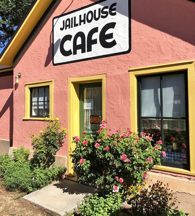 Pink walls framed by yellow trim and accented with blooming roses—this entrance says "come for the novelty, stay for the food." A warm welcome to breakfast paradise.