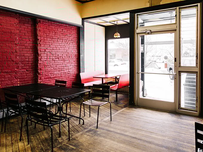 The dining area's red brick wall and wooden floors create an atmosphere that says, "Relax, stay awhile, order that second pizza."