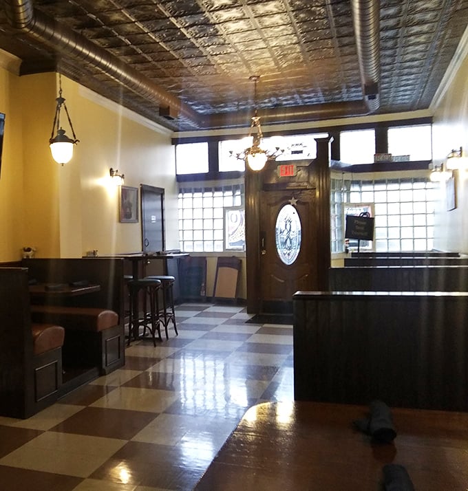 The entryway's gleaming checkerboard floor and ornate ceiling set the stage for the culinary performance that awaits inside.