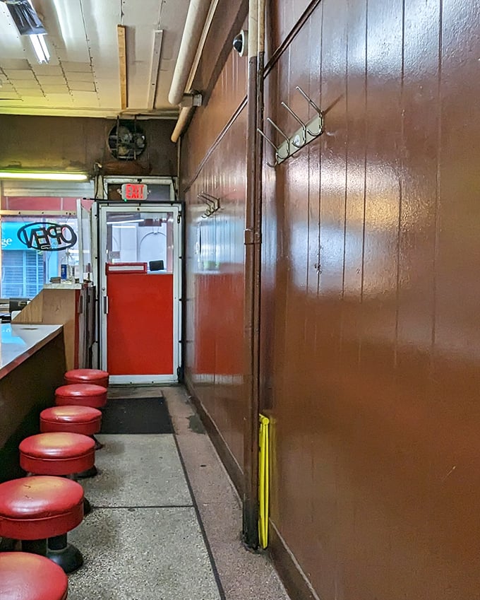 The exit corridor lined with those classic red stools—each one having supported countless satisfied customers over decades of Detroit dining history.