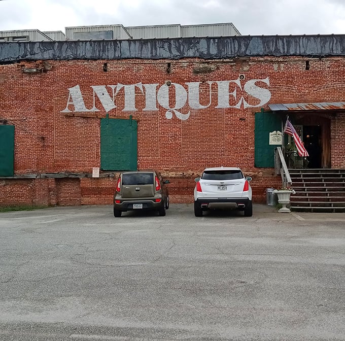 The exterior view that says, "Yes, we're serious about antiques" with all the subtlety of a brick wall—because it literally is a brick wall with "ANTIQUES" painted on it.