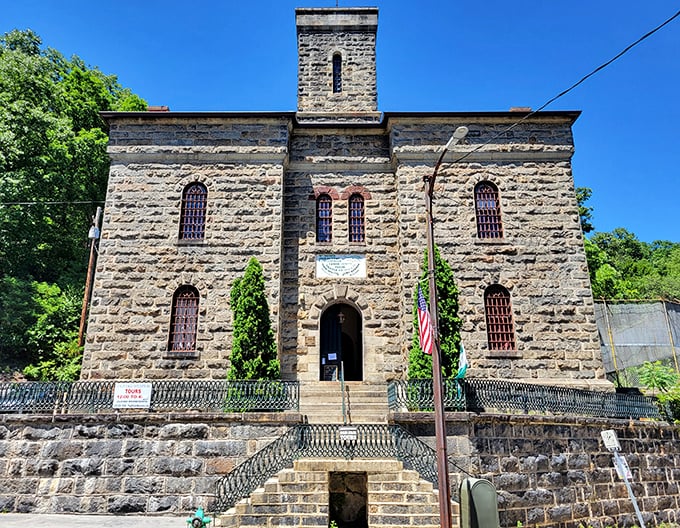 The Old Jail Museum's impressive stone façade, complete with barred windows and American flag, stands as a preserved piece of Pennsylvania history.