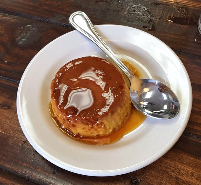 The flan arrives glistening with caramel like it's ready for its close-up—a jiggly finale to a meal that's already stolen your heart.