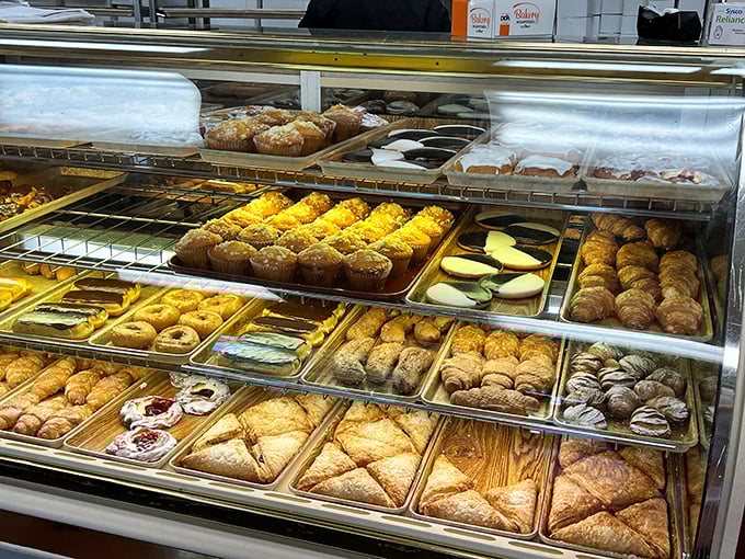 The display case—a museum of Italian pastry where every shelf tells a different delicious story and calories dare not be counted.