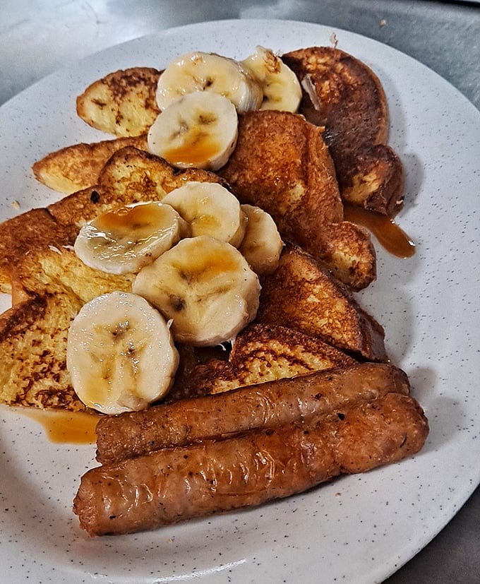 French toast that makes you question why you'd eat anything else for breakfast. Those bananas aren't garnish – they're co-stars in this morning masterpiece.