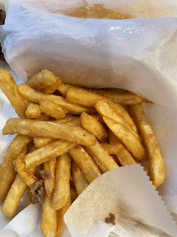Golden fries nestled in their paper cocoon—crispy on the outside, fluffy within, and destined for a brief but meaningful existence.