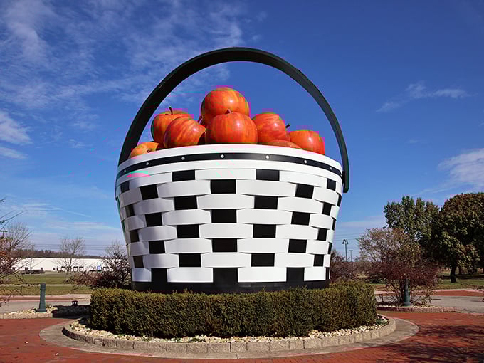 Against a perfect blue sky, the basket achieves peak roadside attraction status—simultaneously ridiculous and magnificent, exactly as American folk art should be.