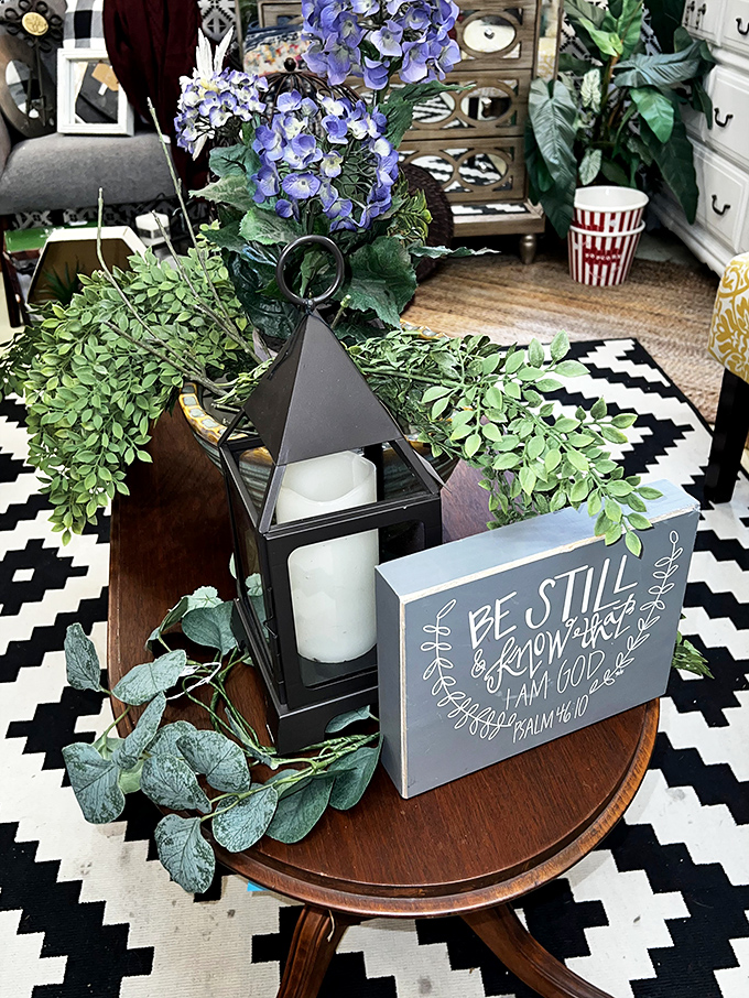 A vignette that perfectly captures the modern farmhouse aesthetic—where scripture meets greenery and geometric patterns in perfect harmony.