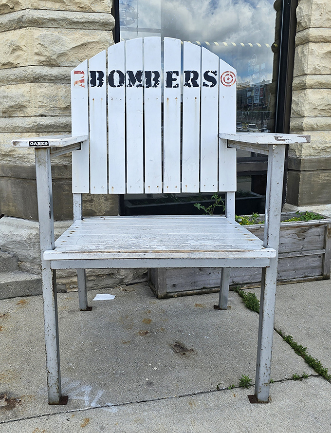This white Adirondack chair isn't just outdoor seating—it's a throne for burger royalty, emblazoned with the restaurant's logo for maximum Instagram potential.