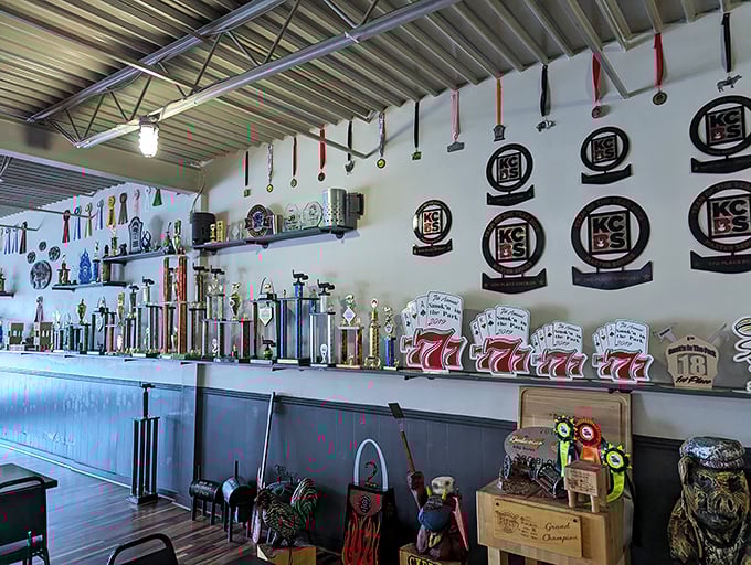 A wall of glory that speaks volumes. These trophies and medals aren't just decoration—they're a resume of smoky excellence.