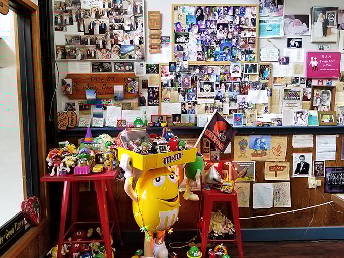 Every inch of wall space tells a story – part community bulletin board, part family album, with enough M&M memorabilia to sweeten the deal.