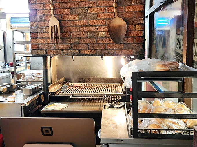 The legendary charcoal grill where burger magic happens – those grill marks aren't just for show, they're flavor geography mapping deliciousness.