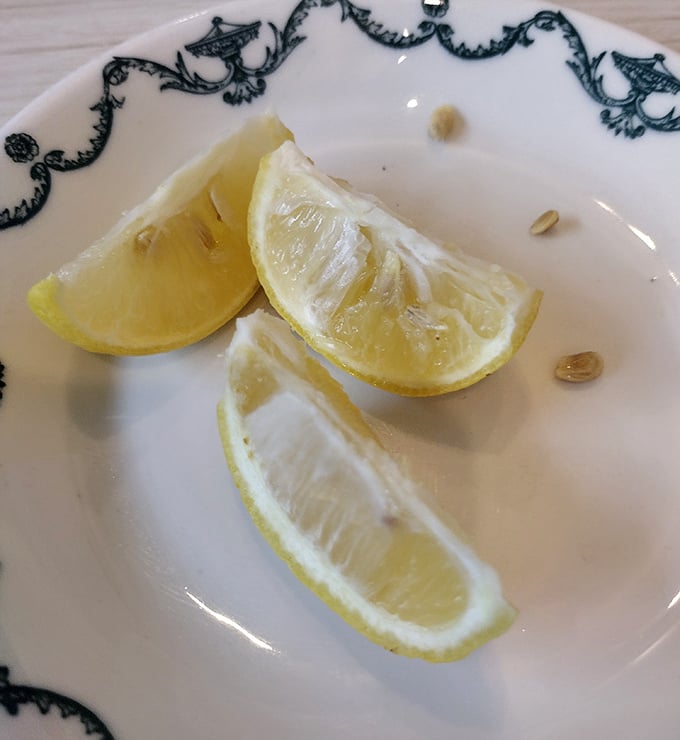 These lemon wedges aren't just garnish—they're the finishing touch that brightens seafood dishes and iced tea alike, a small but crucial detail.