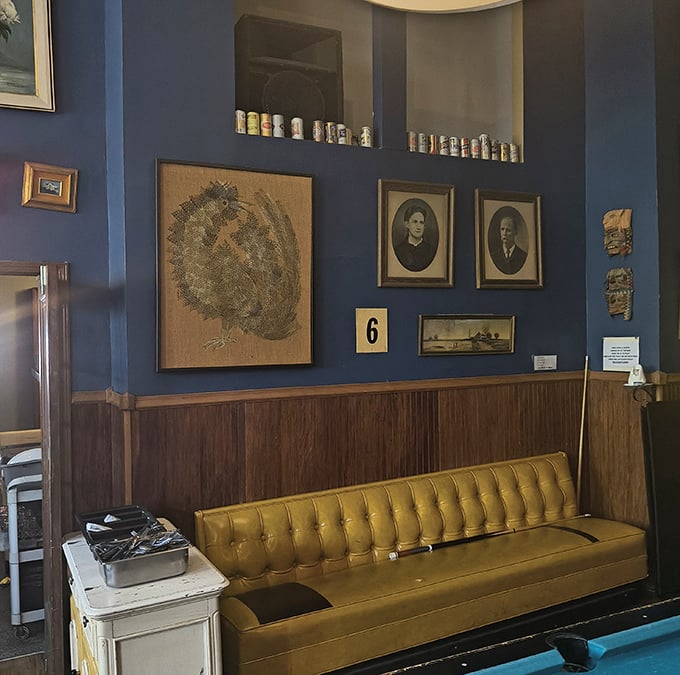 That mustard-yellow tufted bench against navy blue walls isn't just seating – it's a visual declaration that this place understands both comfort and style.