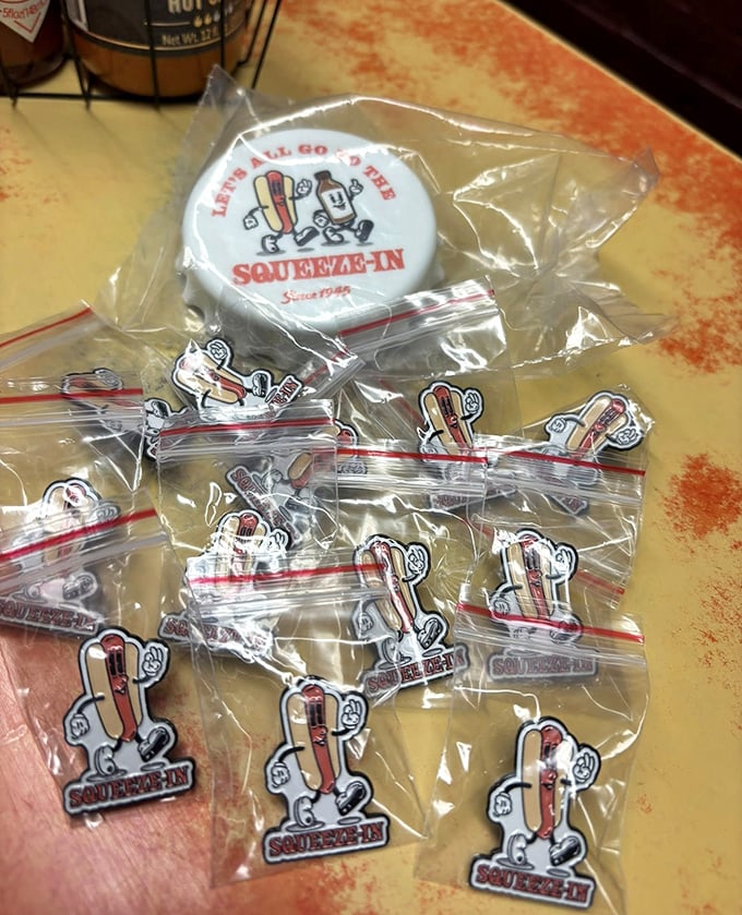 Squeeze-In merchandise that lets you take the experience home. That cartoon hot dog mascot has witnessed decades of happy customers and empty plates.