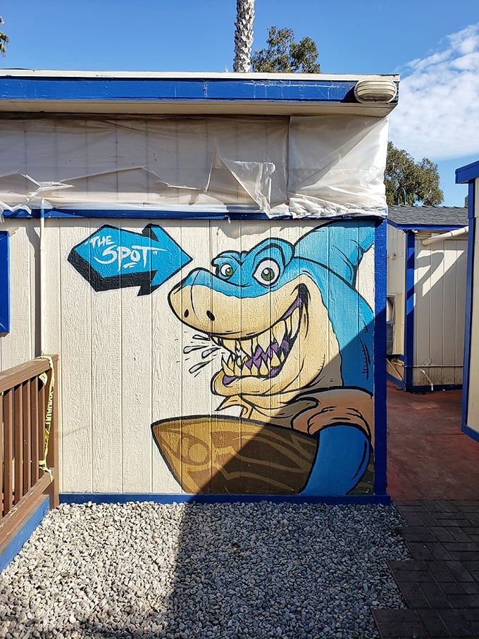 A shark with a surfboard—because California. This playful mural captures the laid-back beach vibe that makes The Spot more than just a meal.