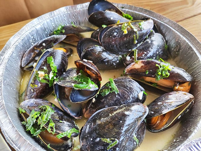 Steamed mussels bathed in fragrant broth become edible treasure chests, each shell opening to reveal a morsel worth the minor struggle of extraction.