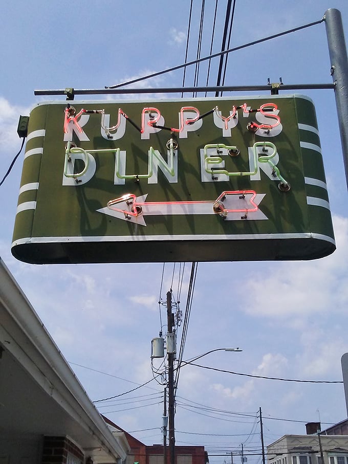 That vintage neon sign doesn't just advertise a restaurant—it's a glowing reminder of an era when diners were the original social networks, connecting communities one cup of coffee at a time.
