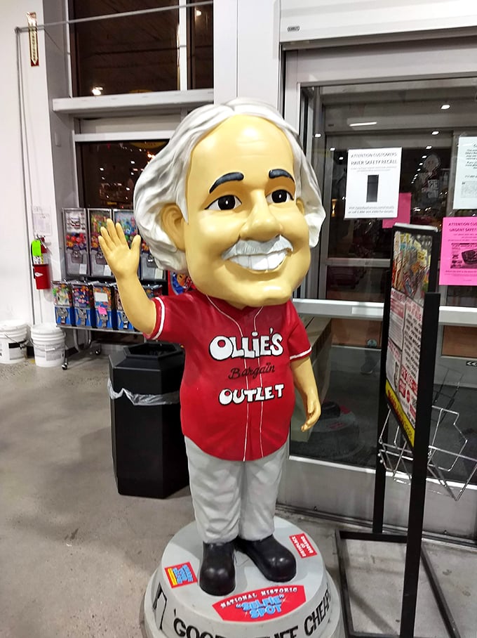 The Ollie's mascot stands guard near the entrance, his permanent smile suggesting he knows exactly what treasures await inside. Bargain hunting personified.