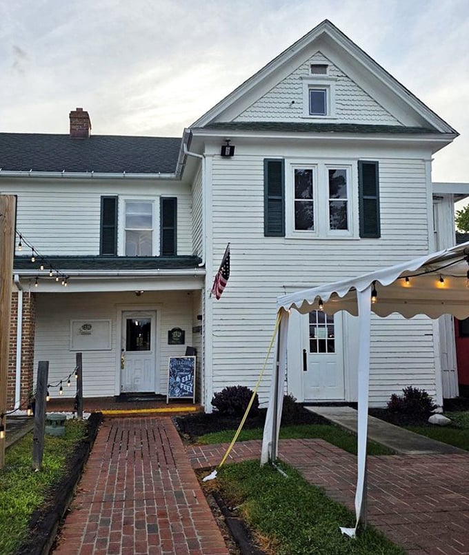 The approach to The Farmhouse feels like discovering a secret—a white clapboard treasure at the end of a brick path.