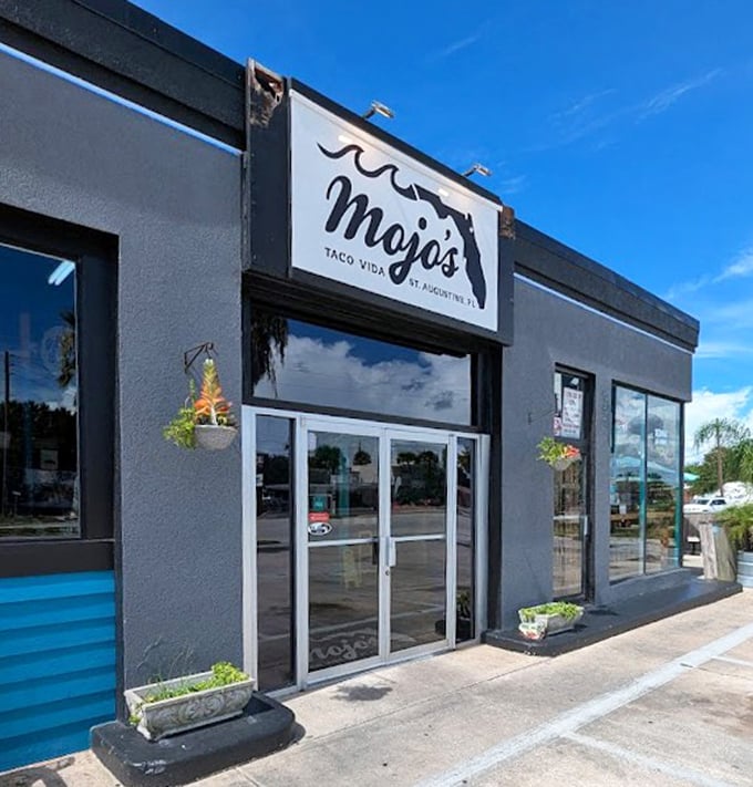 A storefront that balances sleek modernity with approachable charm. Those planters aren't just decorative—they're saying "fresh ingredients inside!"