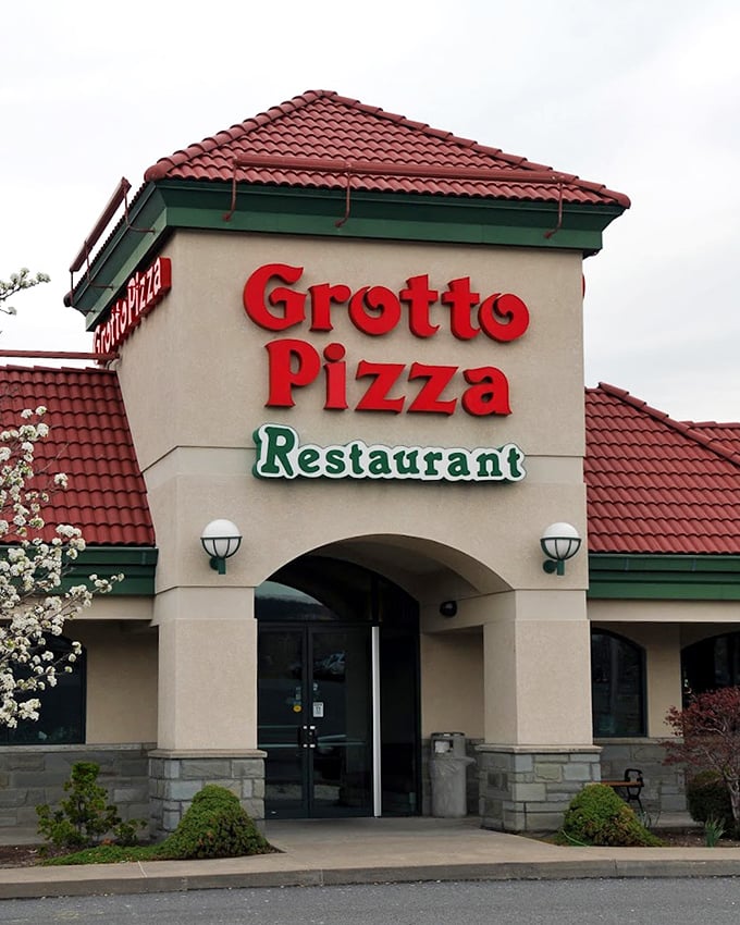 Spring blossoms frame the entrance like Mother Nature herself is giving this pizza joint her official endorsement.