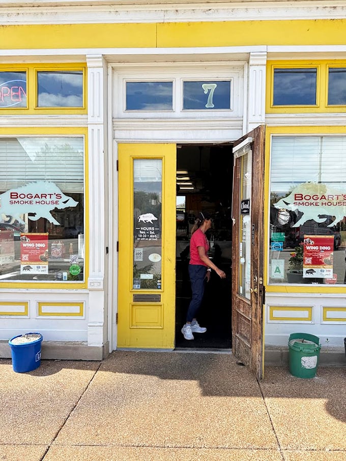 The yellow door swings open to welcome another hungry pilgrim into the temple of smoke. The journey to BBQ nirvana begins here.