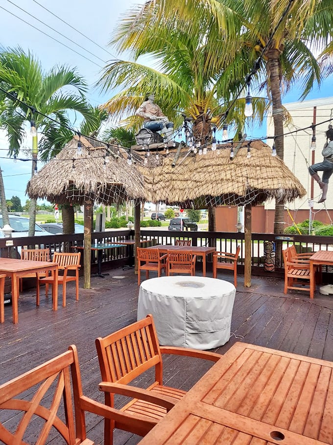 The outdoor dining area—where palm trees sway, ocean breezes play, and you can pretend you caught that seafood yourself just hours ago.