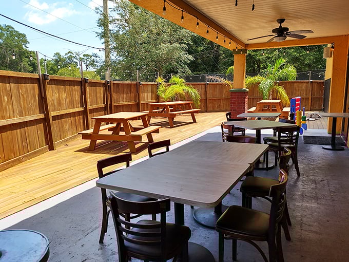 Florida dining at its most authentic – an outdoor patio where sea breezes, ceiling fans, and cold drinks create the perfect post-beach atmosphere. 
