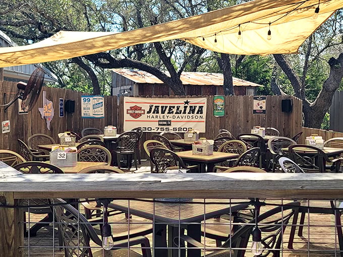 The outdoor dining area—where motorcyclists, wine tourists, and locals gather under shade trees to debate which is better: the burger or the view.