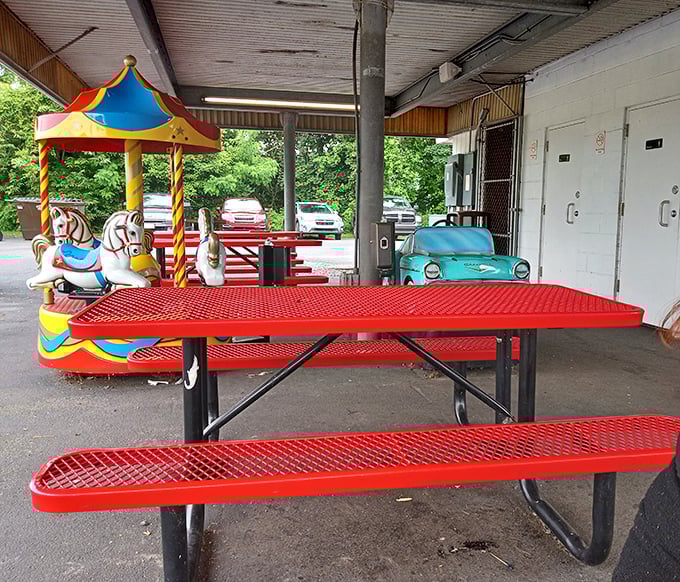 Bright red picnic tables invite you to enjoy your meal al fresco, with vintage kiddie rides standing by for post-meal entertainment.