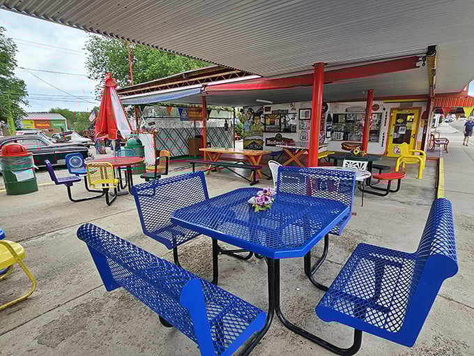 The outdoor dining room where strangers share tables and leave as friends. These colorful metal chairs have supported thousands of happy, full travelers.