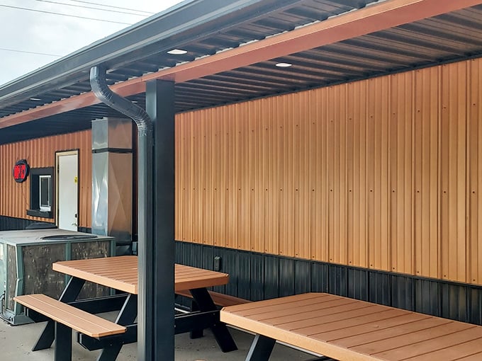 Outdoor seating that's not trying to impress anyone – just honest picnic tables where the only thing that matters is what's on your tray.