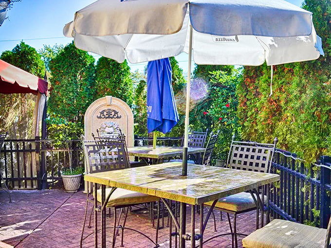 Outdoor dining that feels like a secret garden escape. Those umbrellas aren't just providing shade—they're framing perfect summer memories waiting to happen.