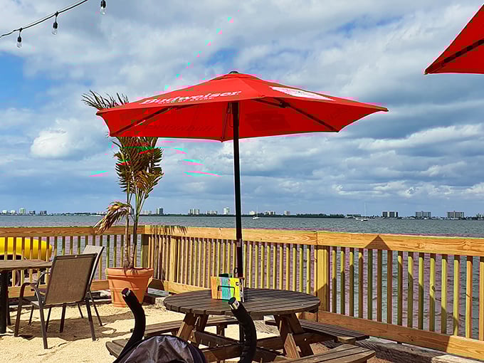 Waterfront dining with Budweiser umbrellas—because sometimes paradise doesn't need to be fancy, it just needs to be authentic and have a great view.