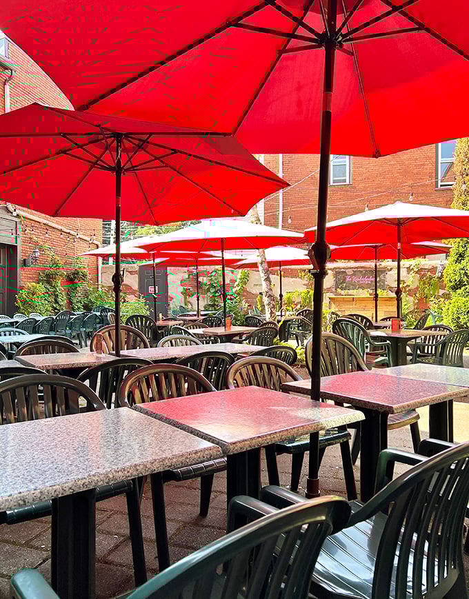 The outdoor patio's cheerful red umbrellas create an oasis where summer afternoons stretch lazily into evening, one bite of good food at a time.