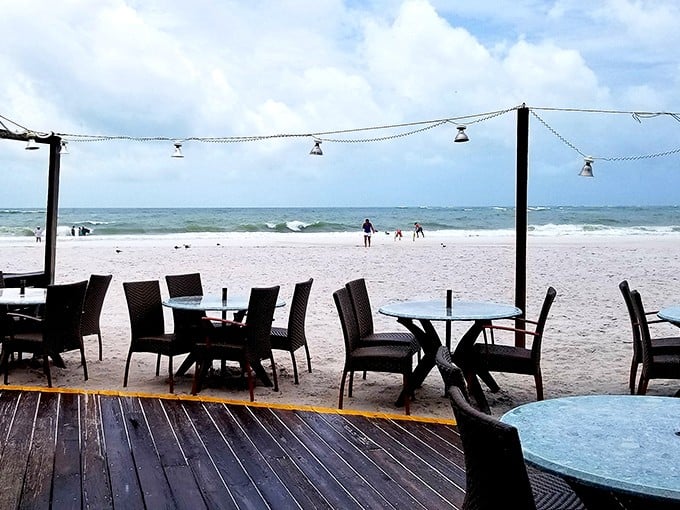 Dining with your toes practically in the sand—where the boundary between restaurant and beach blurs like your worries after that second cocktail.