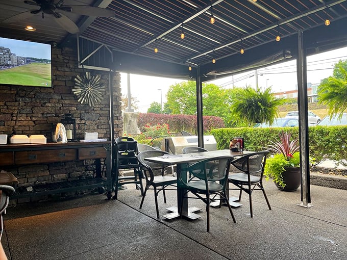 Outdoor seating where fresh air enhances every bite. Stone walls and string lights create the perfect backdrop for your "living my best life" moments.