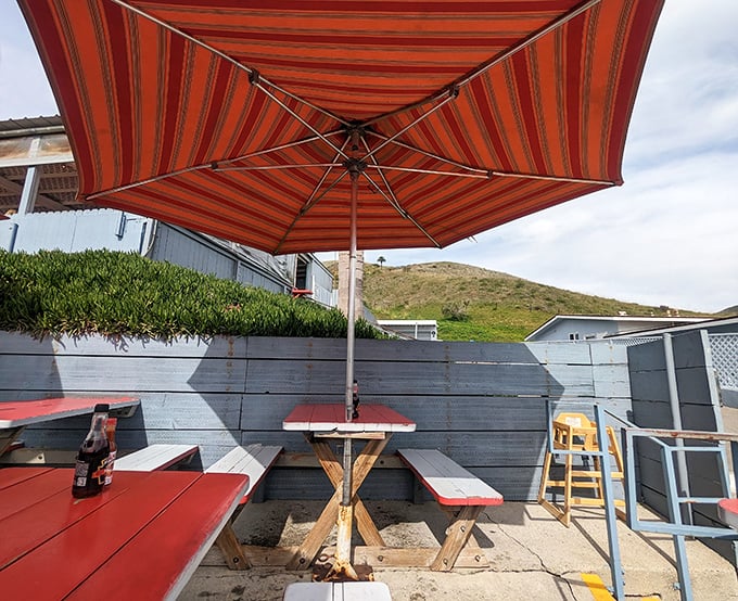 Umbrella-shaded tables where ocean breezes enhance every bite. Some restaurants have ambiance – this place has nature's perfect dining soundtrack.