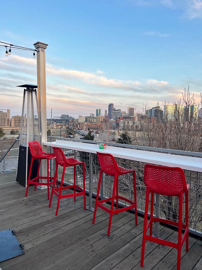 Those red chairs aren't just seating—they're front-row tickets to Denver's most spectacular skyline show, best enjoyed with drink in hand.