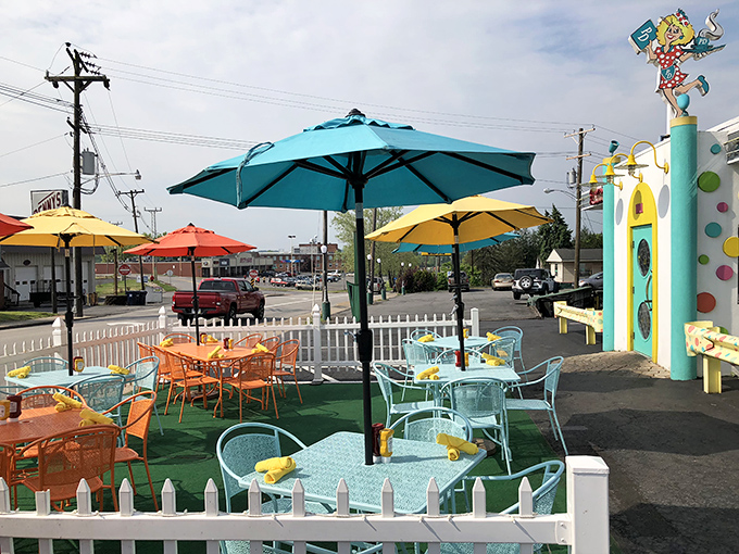 The outdoor seating area pops with colorful umbrellas and cheerful furniture. Like your most stylish friend's patio—if that friend had an unlimited budget and a love for Skittles. 