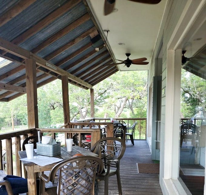The outdoor porch – where Hill Country breezes enhance every bite. Nature's dining room with a view that pairs perfectly with cold beer.