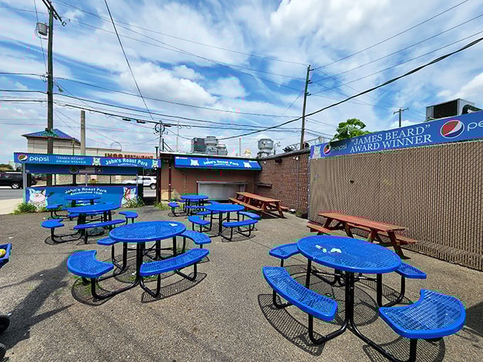 Blue picnic tables create the perfect outdoor dining room where great food tastes even better outdoors.