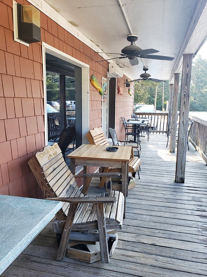 The front porch – where waiting for a table becomes part of the experience, and wooden benches have heard decades of "you should've seen the size of the crab I caught" stories.