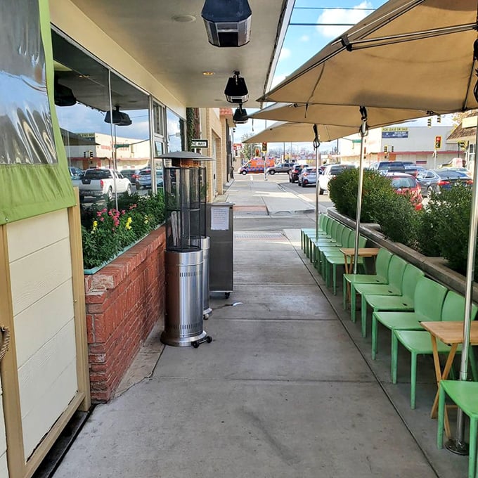 The sidewalk patio—where the green chairs patiently wait for you to waddle out after consuming your body weight in biscuits and gravy.