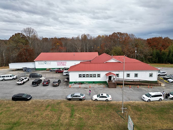 The bird's-eye view reveals Waypoint's true scale—a red-roofed bargain kingdom nestled among autumn trees. This thrift store stands as a monument to second chances.