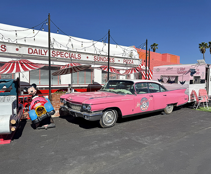 The exterior view that promises good times before you even step inside. That pink Cadillac isn't just transportation – it's a time machine.