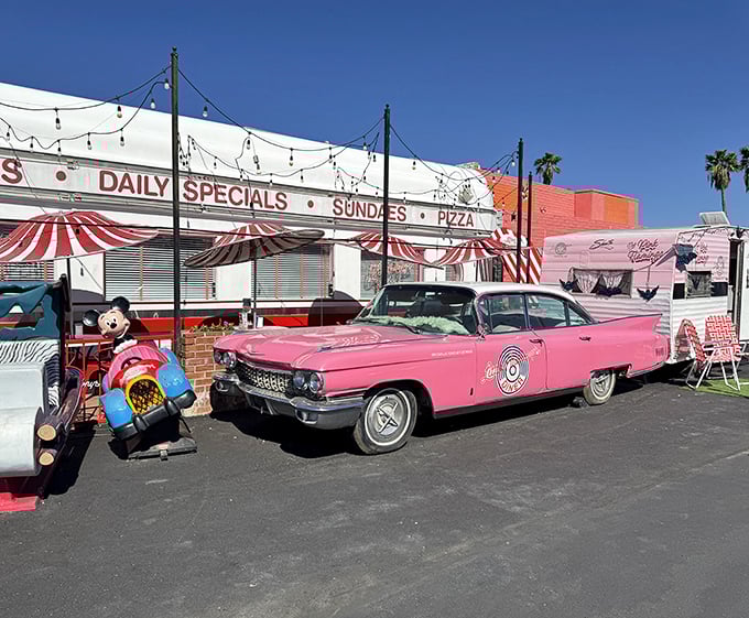 The exterior view that promises good times before you even step inside. That pink Cadillac isn't just transportation – it's a time machine.